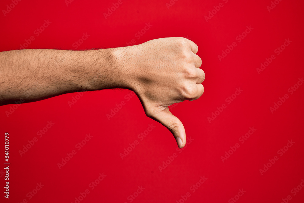 Hand of caucasian young man showing fingers over isolated red ...