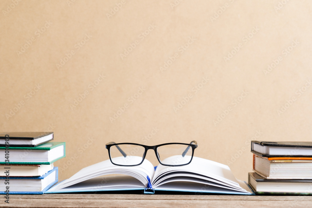 Books and textbook on wooden desk in library, Piles of books on reading ...