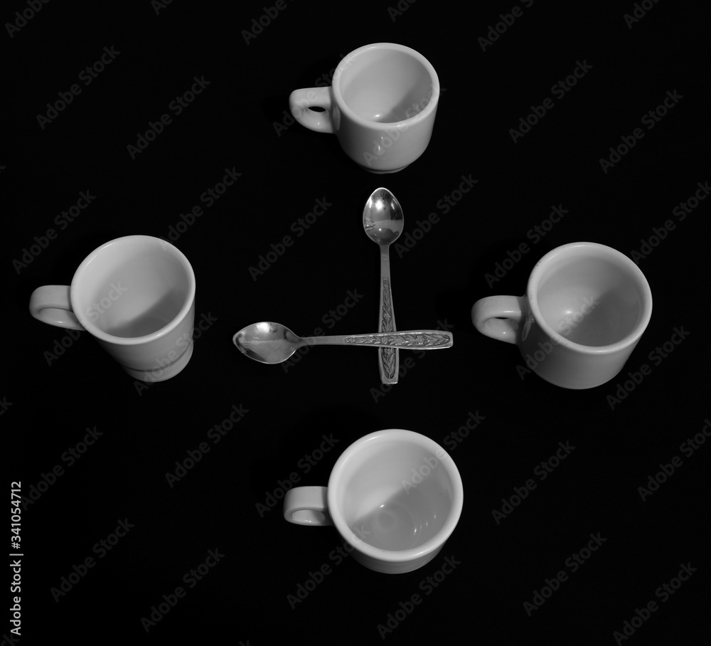 Four coffee cups and two coffee spoons forming a original clock in ...