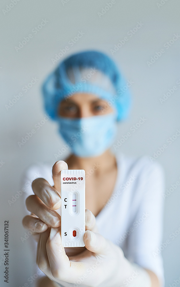 doctor or scientist in laboratory in face mask and gloves holding lab ...