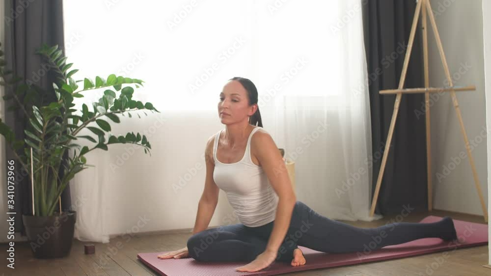 Sporty caucsian woman do one Legged King Pigeon Exercise, in Eka Pada ...