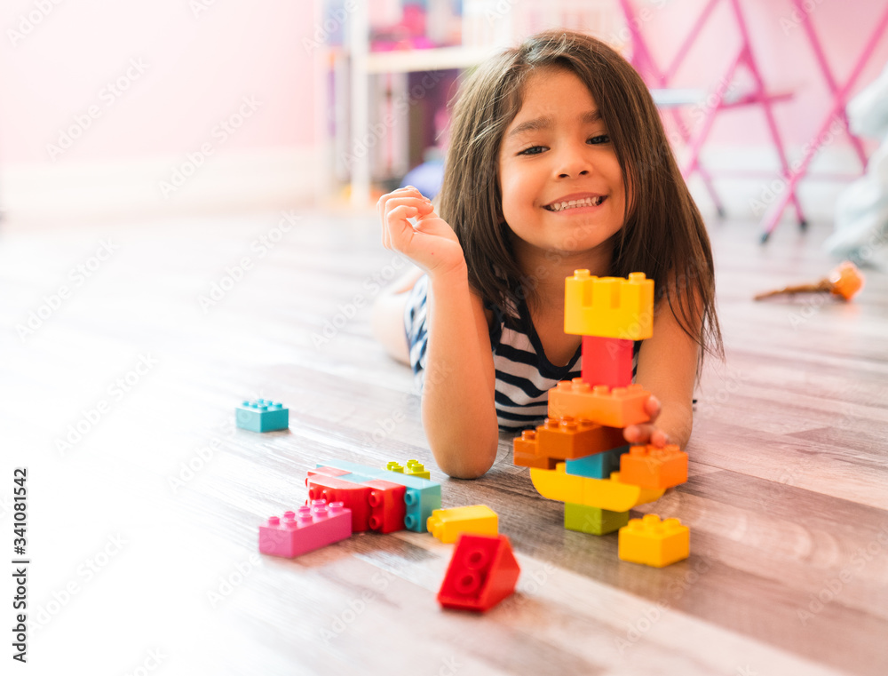 Little Girl Playing With Construction Blocks at Home Stock Photo ...