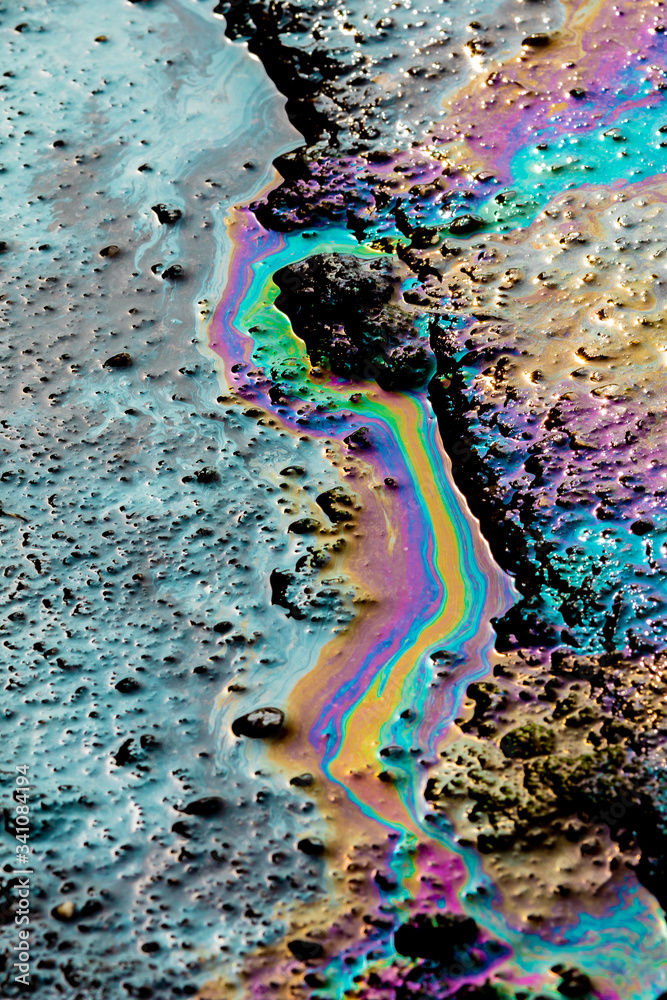Petroleum spill on the ground. Bright colors. Pollution from cars and ...