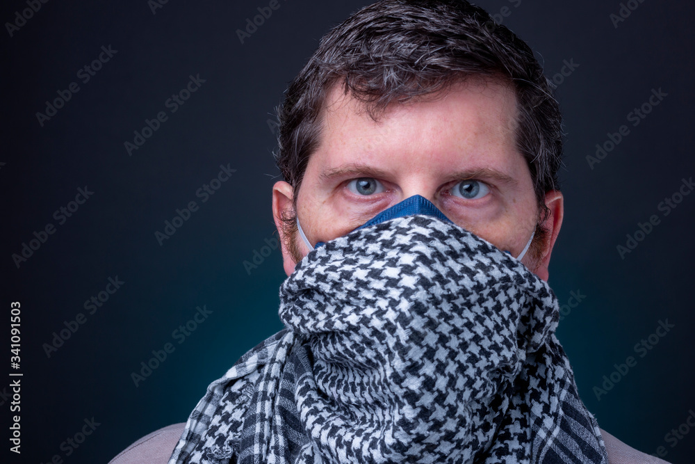 Checker motive scarf over a dark blue N95 respirator face mask on ...
