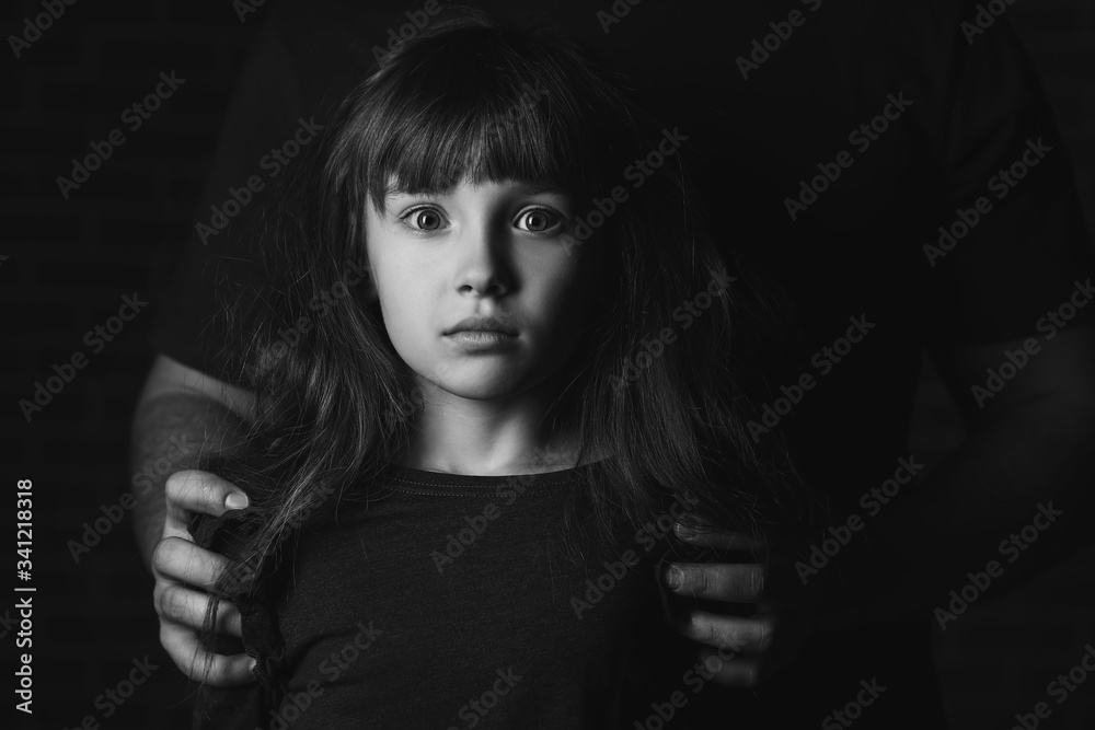 Father with his scared little daughter on dark background. Concept of ...