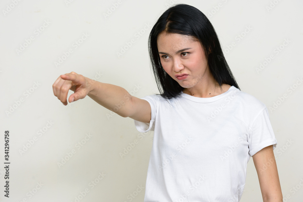 Stressed young Asian woman pointing finger and looking angry Stock ...