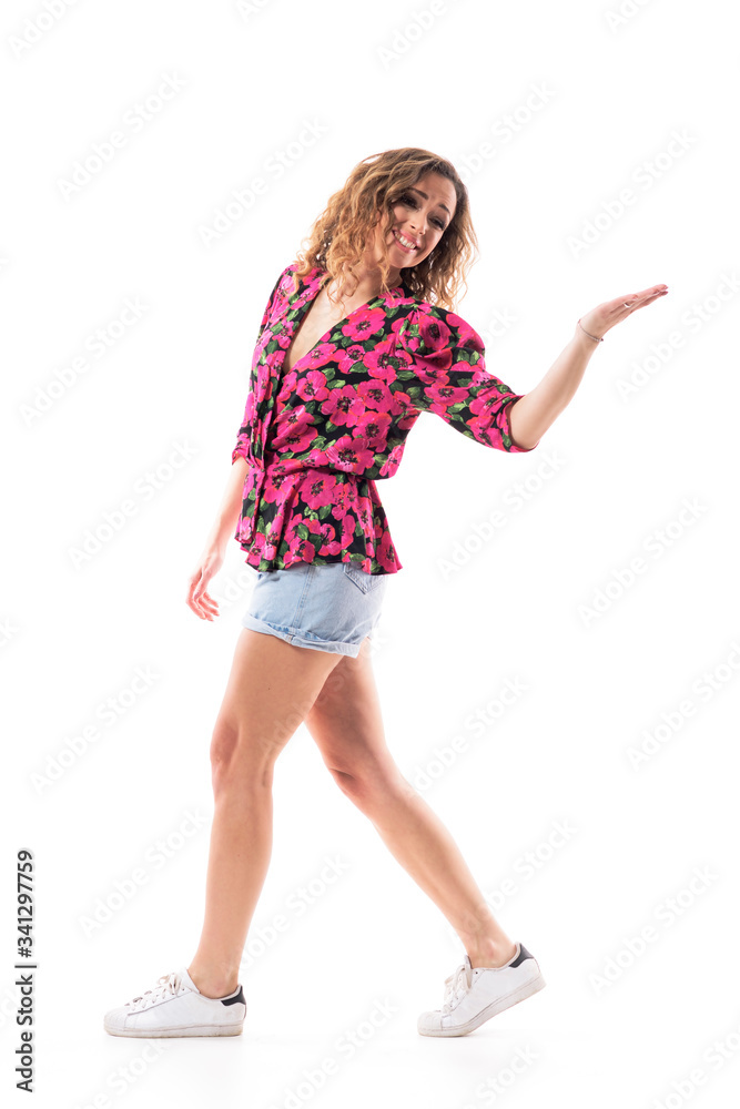 Side view of happy young woman walking turning back and sending goodbye ...