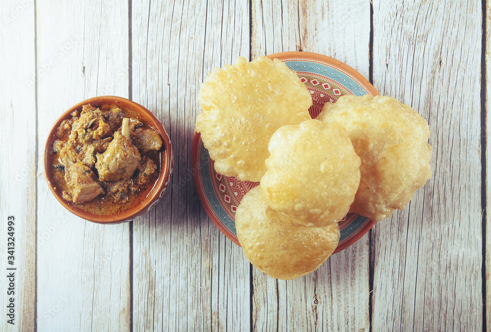 South Indian traditional food Poori or puri with country chicken curry ...