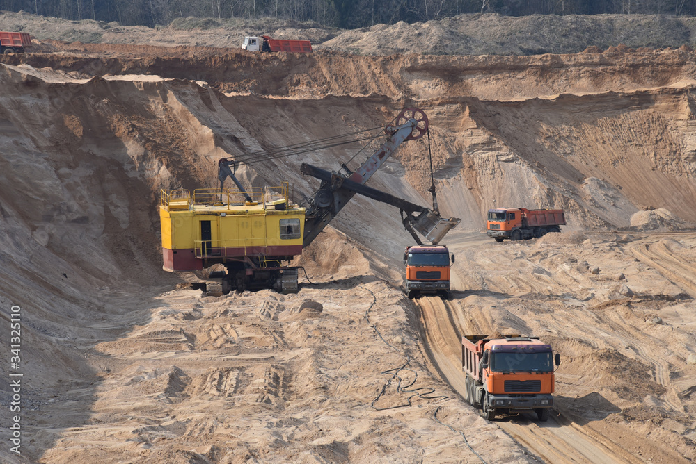 Largest mining excavator with electric shovel loading sand into dump ...