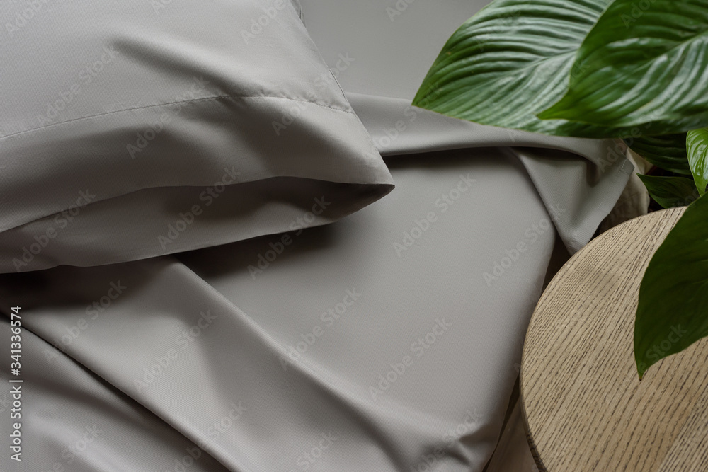 Bed linen in gray, silk fabric texture, bedclothes Stock Photo | Adobe ...