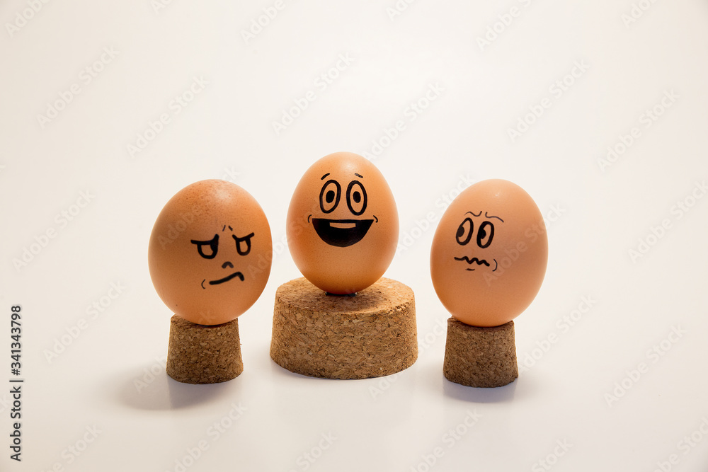 Egg with face standing in the middle of venvious and angry eggs. Cork ...
