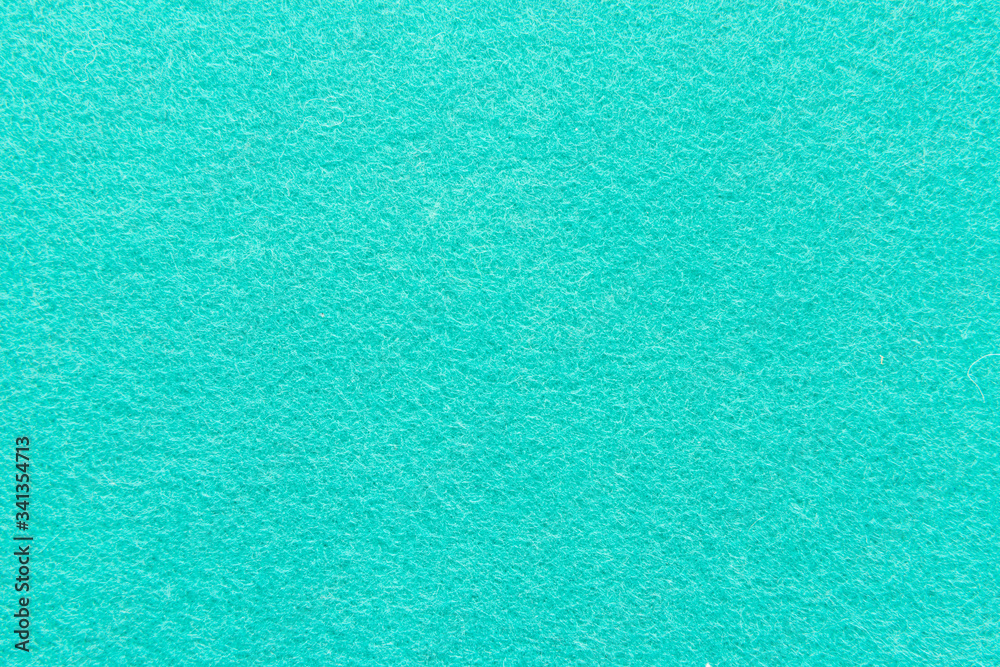 High resolution close up of bright cyane felt fabric texture of rough ...