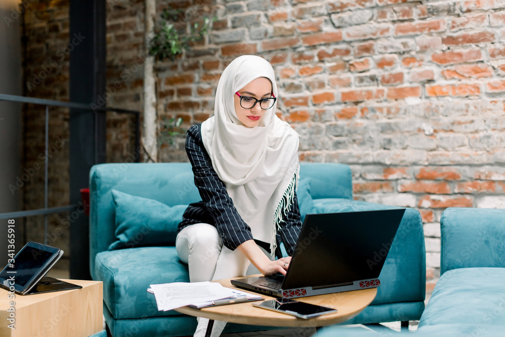 Professional young muslim business woman, wearing white hijab, using ...