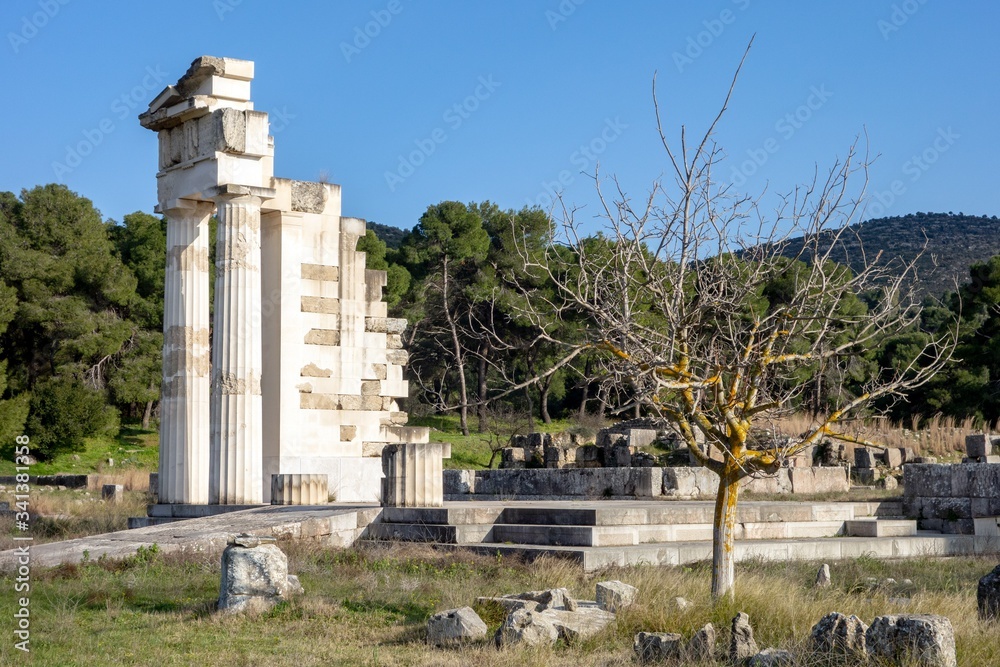 Temple of Asklepios at Epidaurus with a tree in foreground at sunset ...