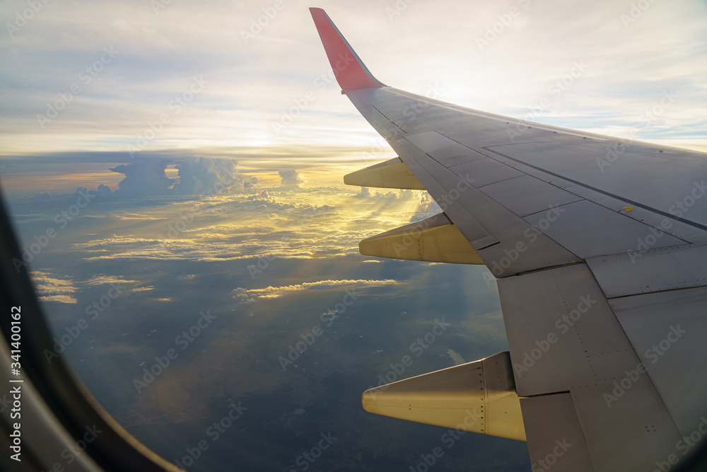 Beautiful sunset, sky on the top view, airplane flying view from inside ...
