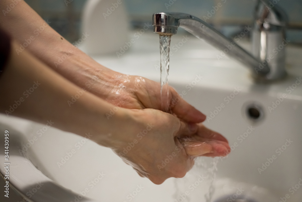 Adult woman washing hands with antibacterial soap. Hygiene concept ...
