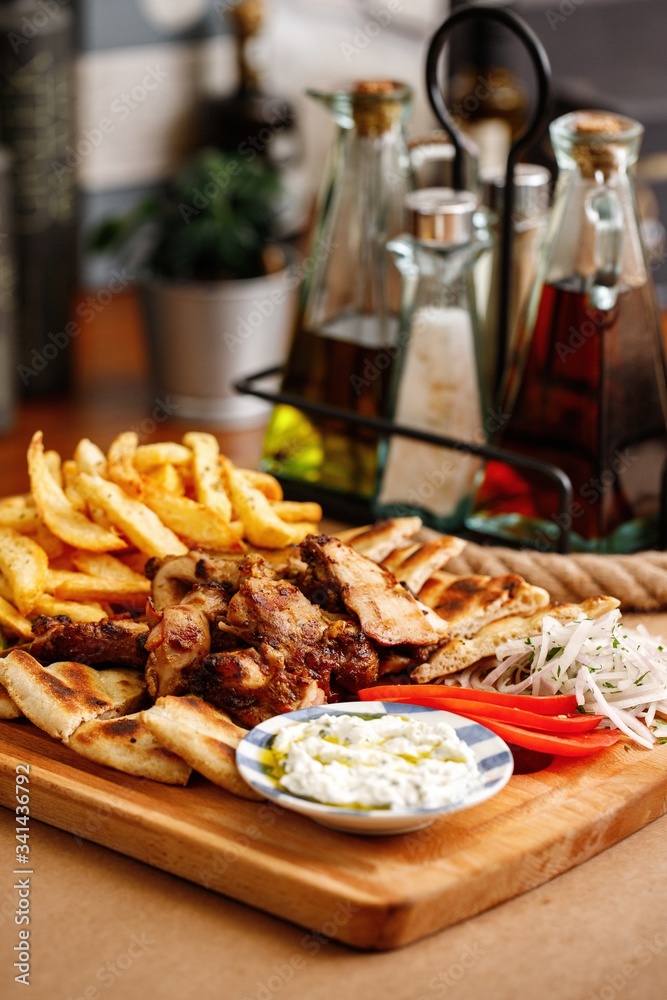 Chicken kontosouvli marinated with fresh herbs with potato fires and ...