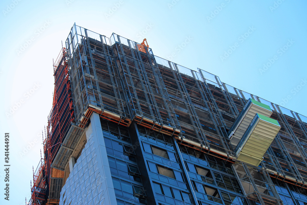 Top of a high rise construction site showing scaffolding, loading ...