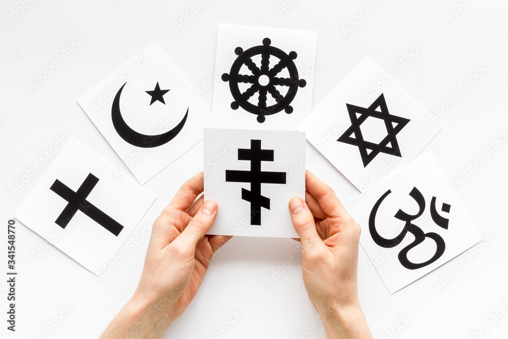 Choose religion concept. Hands with Orthodox cross near world religions ...
