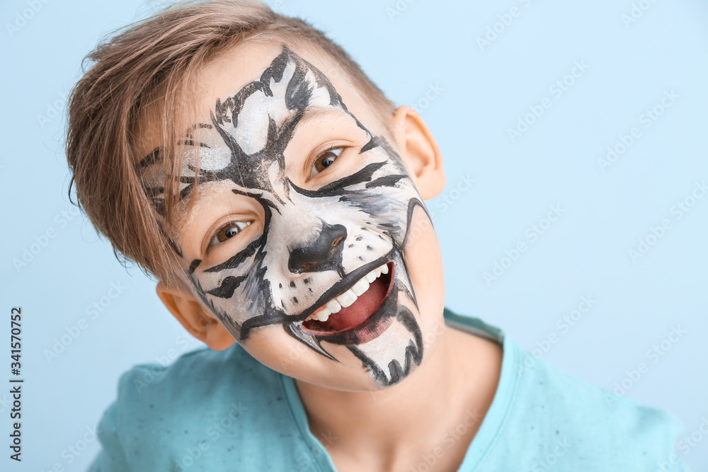 Funny little boy with face painting on color background Stock Photo ...