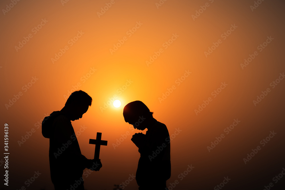 Two christian praying in morning time with sun light background ...