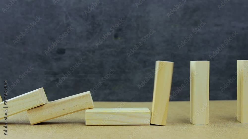 Social distance during a pandemic concept. Side view of falling wooden ...