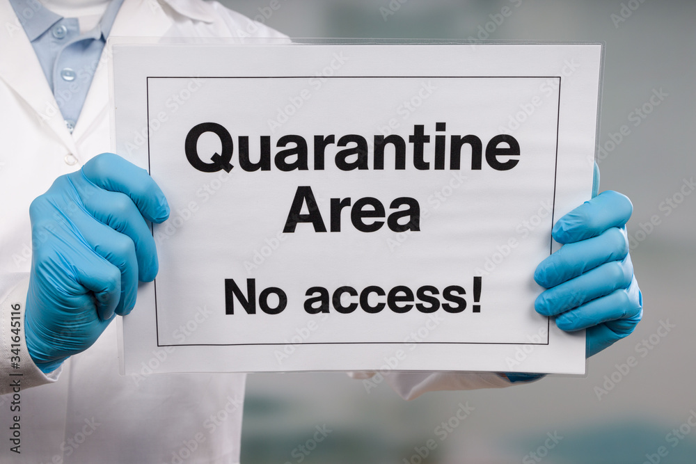 Doctor's hand in medical gloves showing quarantine sign in front of a ...