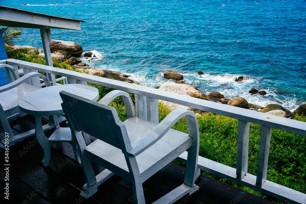 Nice sea view from a balcony of a hotel. Chair with table set on ...