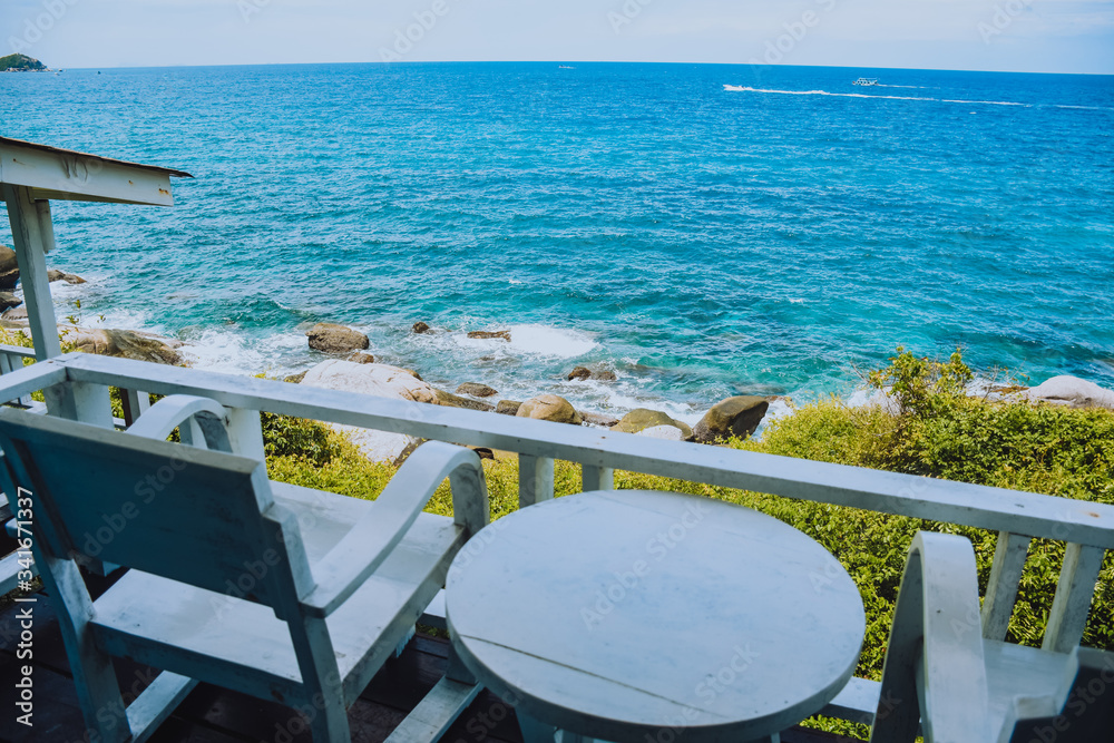 Nice sea view from a balcony of a hotel. Chair with table set on ...