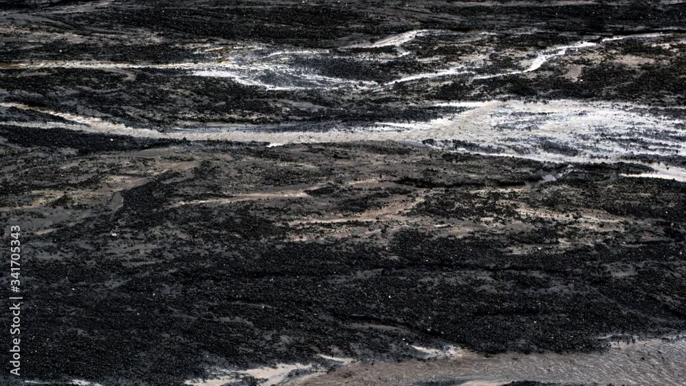 Glacier with ash in the ice with melted water and Icelandic landscape ...