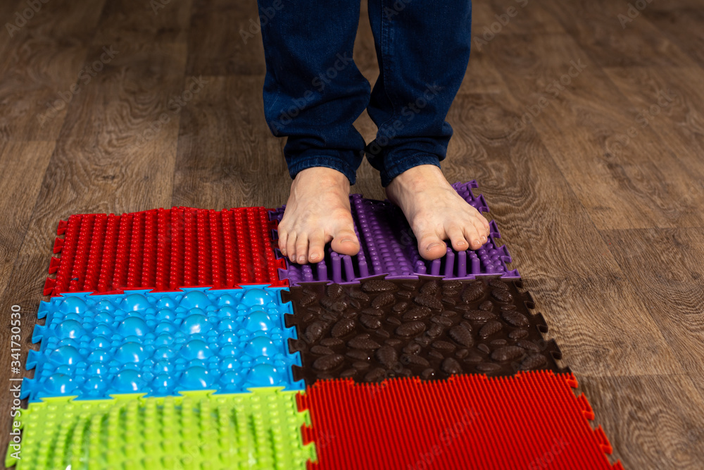 prevention of flat feet. female legs on an orthopedic rug. foot massage ...