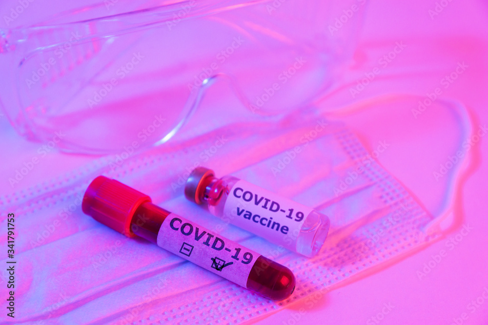 Bottle with vaccine covid-19 and tube blood sample in neon light. Stock ...