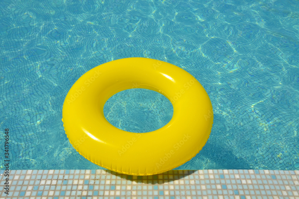 Colorful inflatable tube floating in swimming pool Stock Photo | Adobe ...
