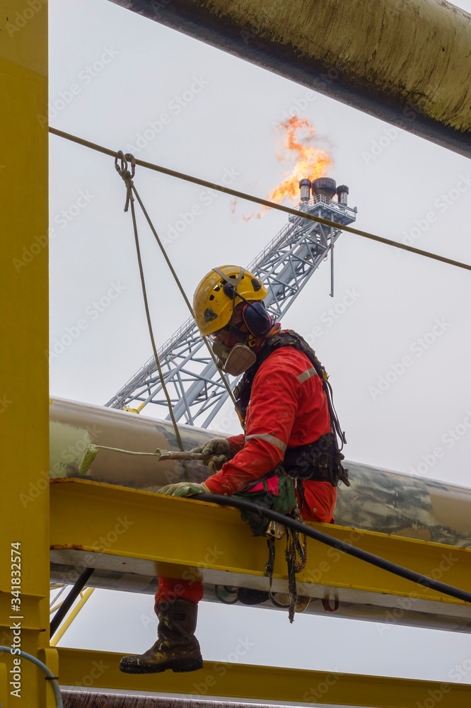 Working at height. An abseiler wearing Personal Protective Equipment ...