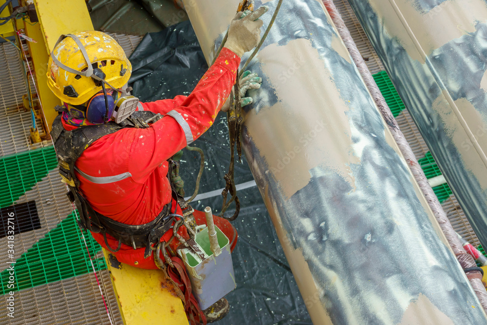 Foto de Working at height. An abseiler wearing Personal Protective ...