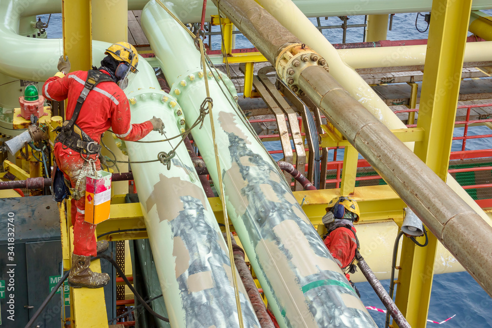 Working at height. A group of abseilers wearing Personal Protective ...