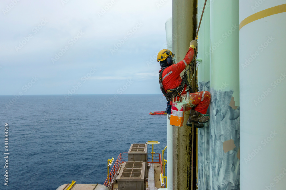 Working at height. An abseiler wearing Personal Protective Equipment ...