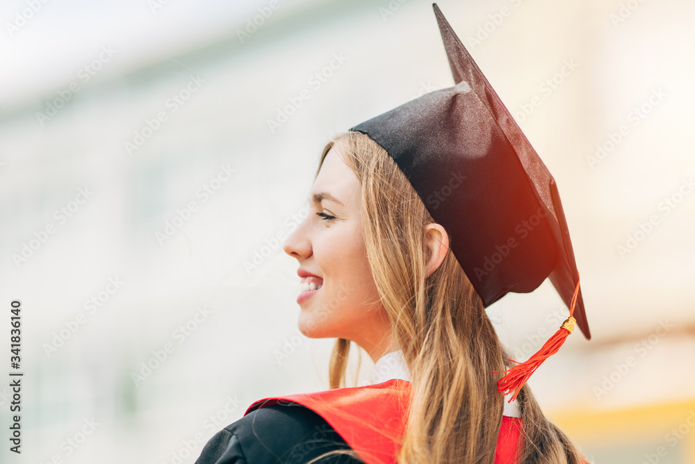 Graduation day, back view, student in a graduation cap and dress. The ...