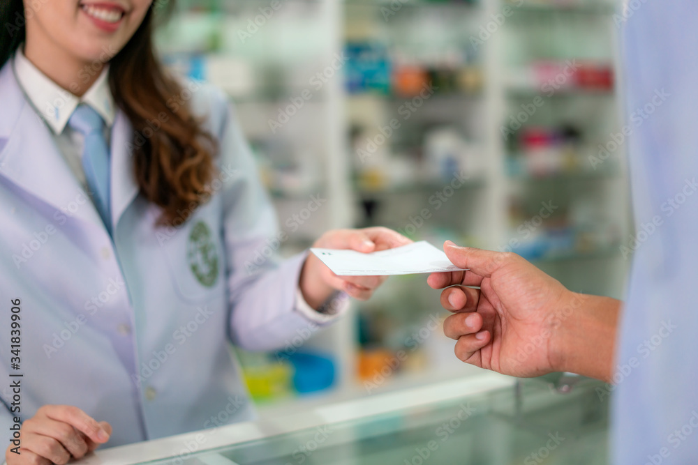 Confident Asian young female pharmacist with a lovely friendly smile ...