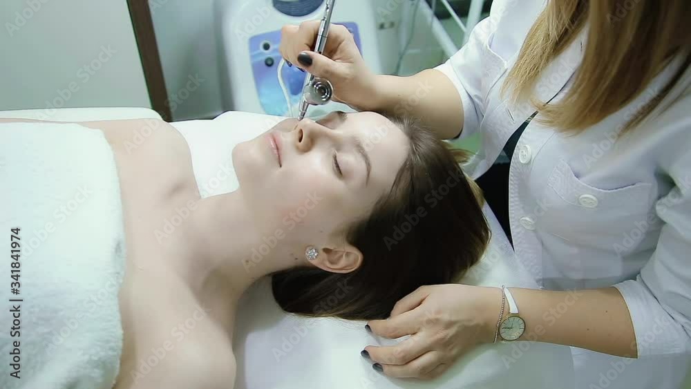 Beautiful young woman getting oxygen facial therapy treatments in a ...