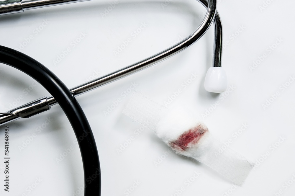 Blood on cotton wool and white plaster on white background with ...