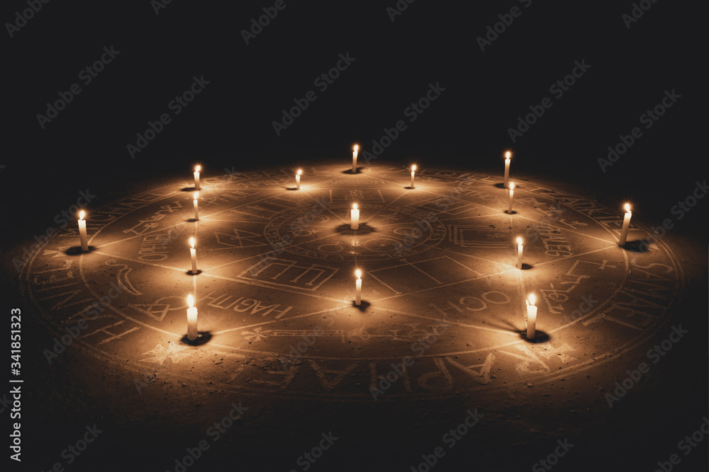 The Seal of the Seven Archangels. Illuminated with candles. Dark ...