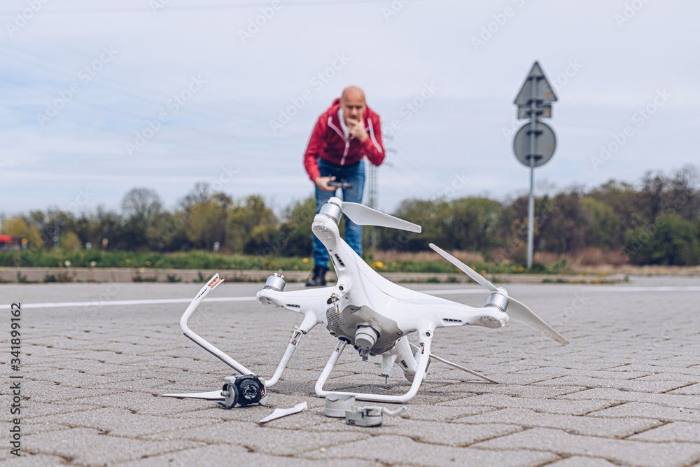 Shocked worried man after his drone crash. Destroyed broken drone Stock ...