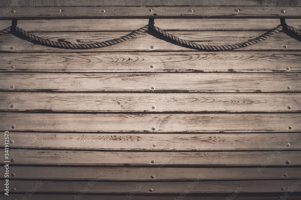 The side of an old wooden boat with ship rope. Marine wood texture ...