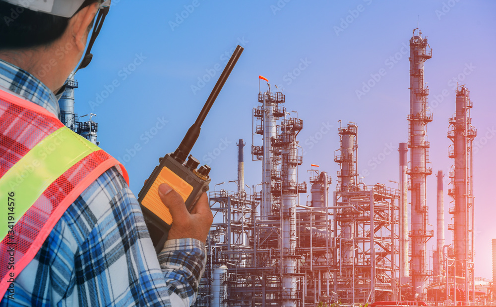 Worker in Oil Refinery discussion and pointing for inspection by hand ...