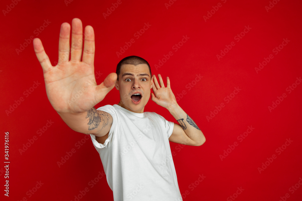 Shocked showing stop gesture. Caucasian young man's portrait isolated ...