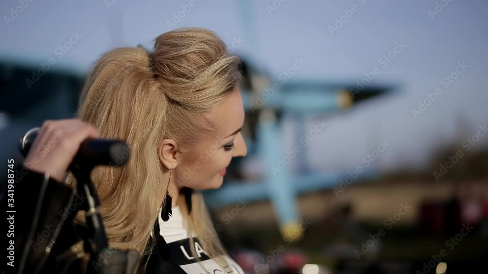 close up. portrait of singer girl standing behind microphone singing ...