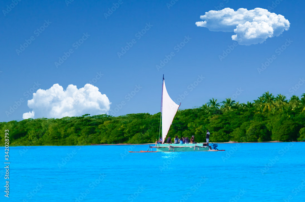 Typical melanesian wooden boat in the Upi bay to reach the Golden bay ...