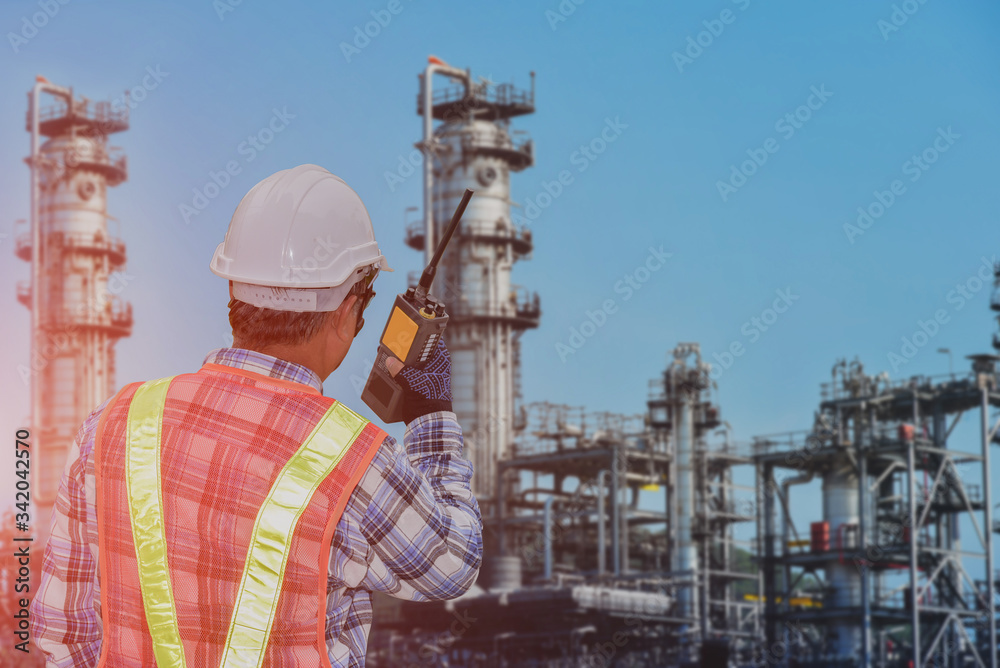 Worker in Oil Refinery discussion and pointing for inspection by hand ...