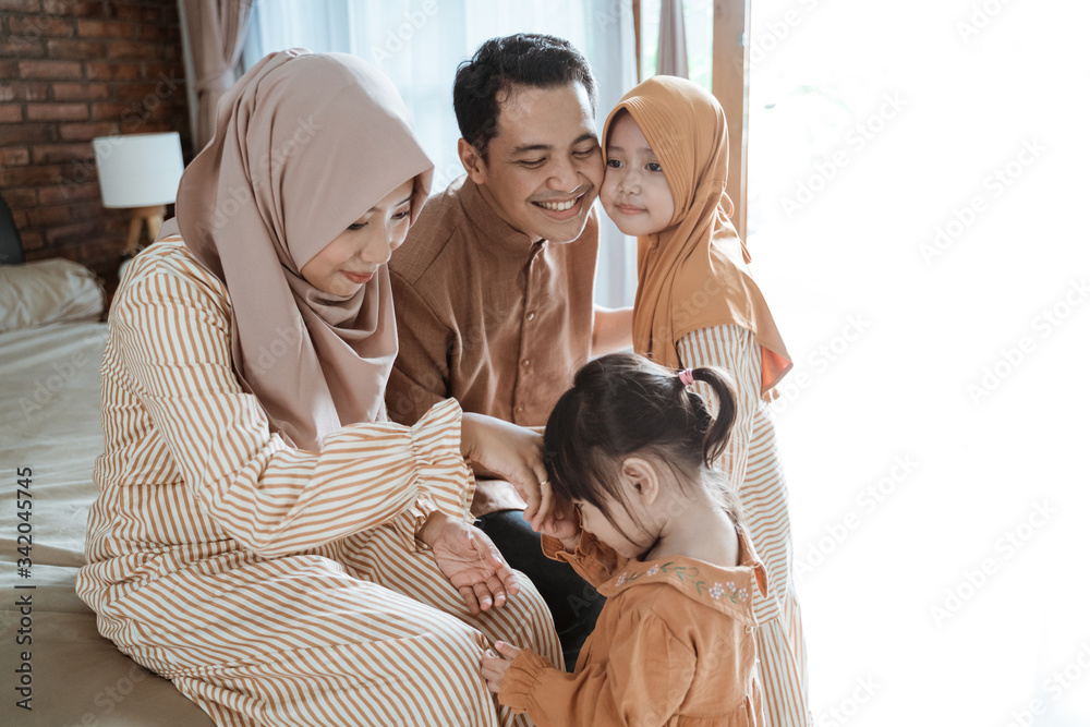 muslim family and kid greeting and asking forgiveness shaking hand on ...